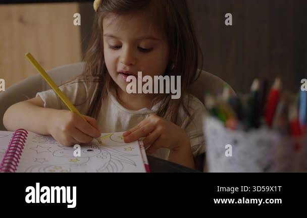 Child sketches happily, Young student drawing with joy, Preschool girl ...