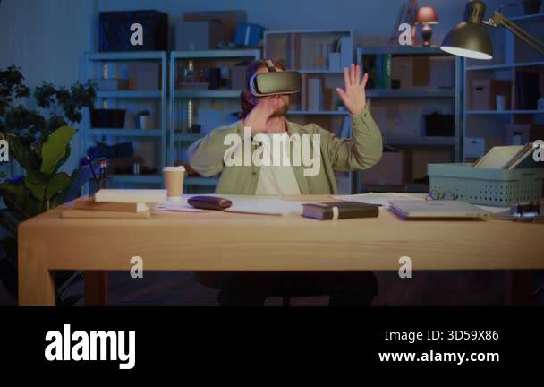 Bearded Man Wearing Virtual Reality Headset While Sitting At Desk With ...