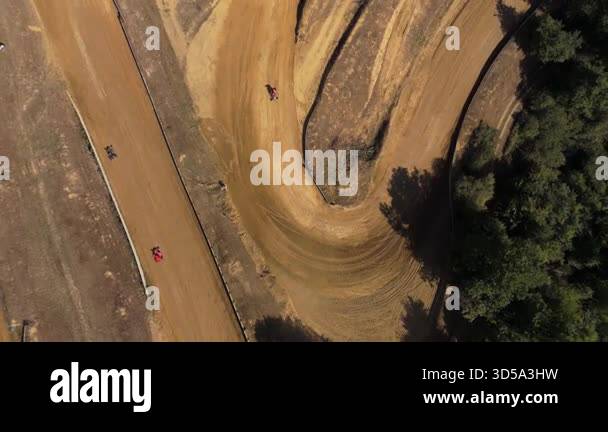 Overhead aerial drone shot of small karts racing and drifting on a ...