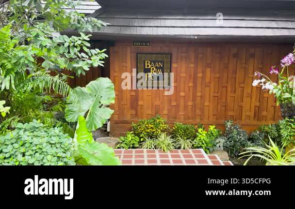 A serene view of lush tropical foliage surrounding the traditional teak ...