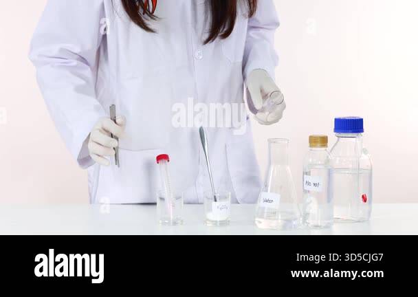 Scientist handling lab equipment for an experiment Stock Video Footage ...