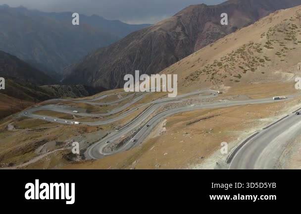 Flying over the mountain road which passing through a mountain pass in ...