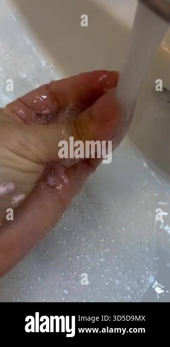 Hand washing under faucet, soap foam, bathroom sink, hygiene ...