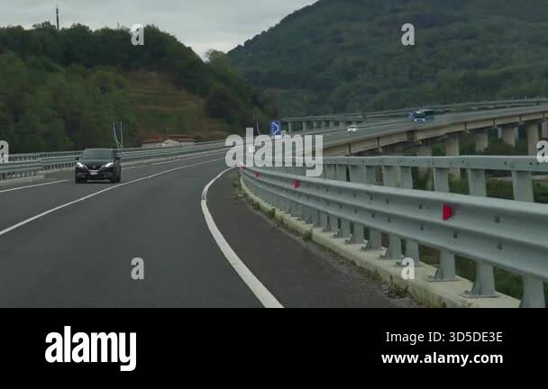 Mountain road. A car is driving along a highway leading to the ...