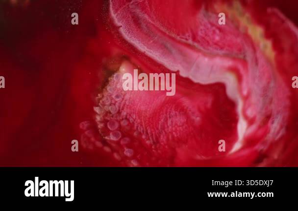 Floating ink. Color mix. Defocused red crimson yellow water emulsion ...