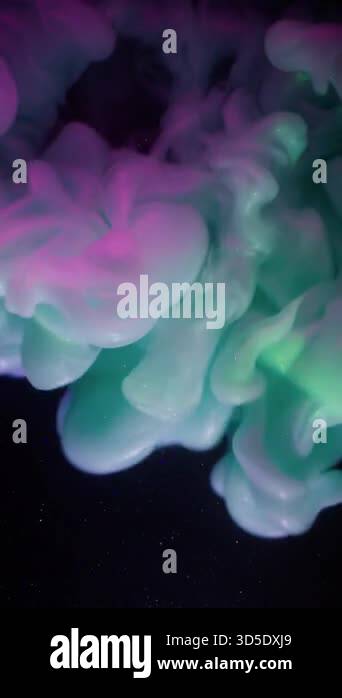Vertical video. Smoke explosion. Paint flow. Neon green purple fluid ...