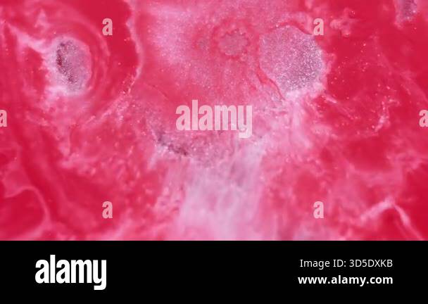 Spilling fluid. Blend texture. Defocused red white color water splash ...