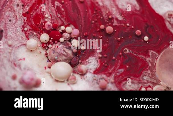 Acrylic bubbles. Paint oil water. Defocused red white pink color ...