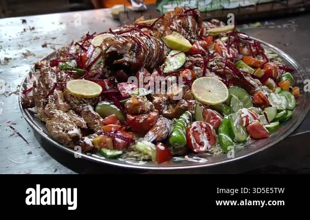 Colorful mixed barbecue grill with rice, veggies, and lemon, presented ...
