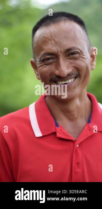Close smiling headshot of a man in a red polo, approachable and ...
