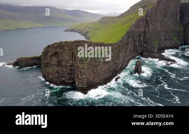Close-up shot of famous Drangarnir cliff with Tindholmur islands in the ...