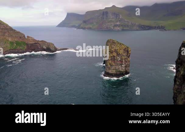 Close-up shot of famous Drangarnir cliff with Tindholmur islands in the ...