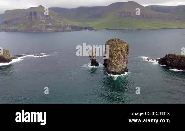 Close-up shot of famous Drangarnir cliff with Tindholmur islands in the ...