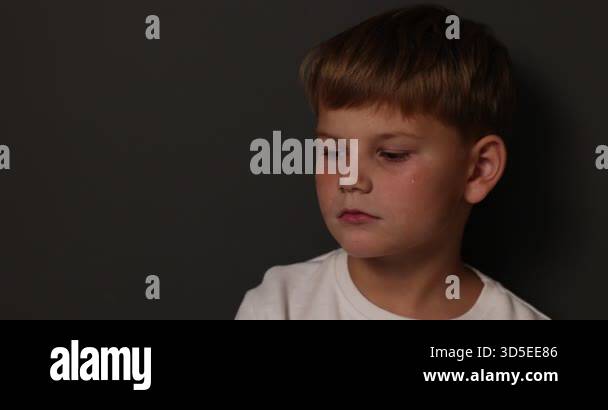 Upset little boy crying on black background Stock Video Footage - Alamy