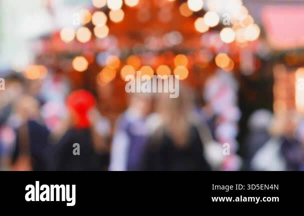 blurred background of busy Christmas market with festive lights and ...