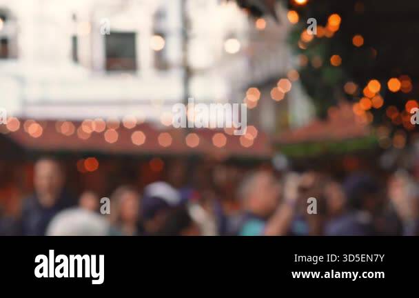 blurred background of busy Christmas market with festive lights and ...