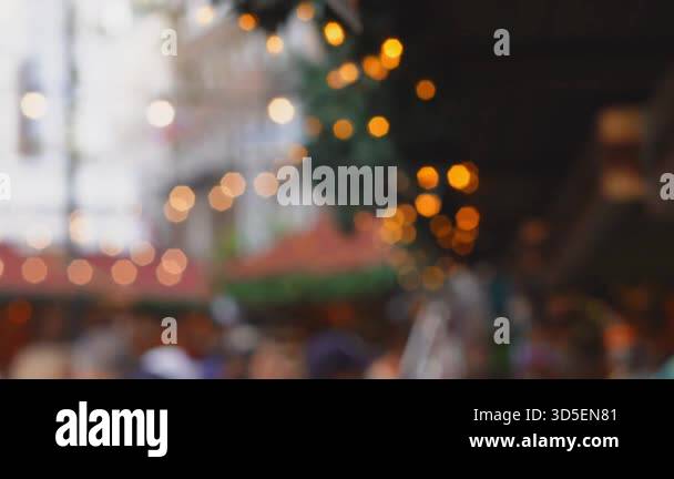 blurred background of busy Christmas market with festive lights and ...