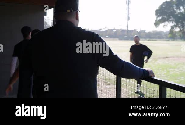 Baseball team following helmet-carrying player into dugout, high-fiving ...