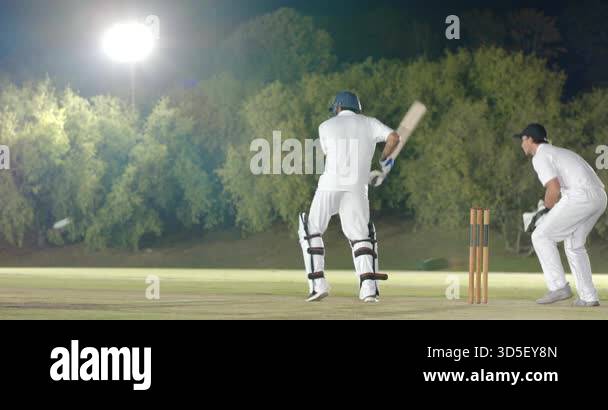 Bowler delivering ball Indian batsman swinging bat to hit ball under ...