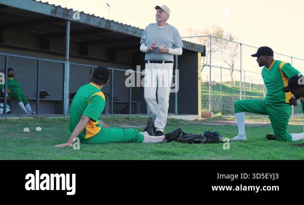 Raising baseball senior White male coach demonstrating pitching grip on ...