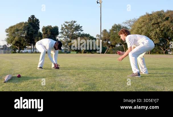 Releasing red ball underarm, male teammates scooping, exchanging it by ...