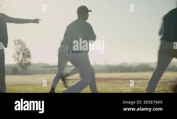 Pointing coach signaling male teammates jogging shuffling around cones ...
