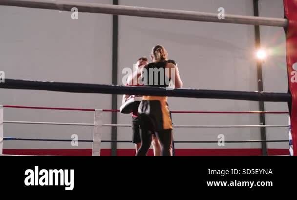 Female boxer following mitts, throwing jabs, crosses, hooks and front ...