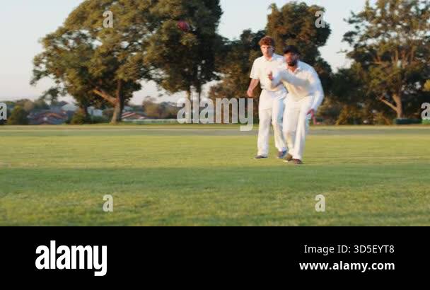 During practice male teammates swinging shot and diving catch cricket ...