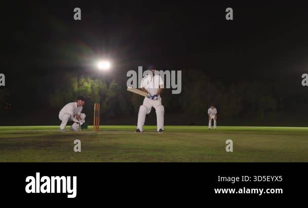 Bowler delivering ball toward Indian batsman defending wicket, fielder ...