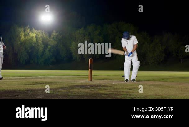 Bowler delivering batsman swinging bat keeper catching team celebrating ...