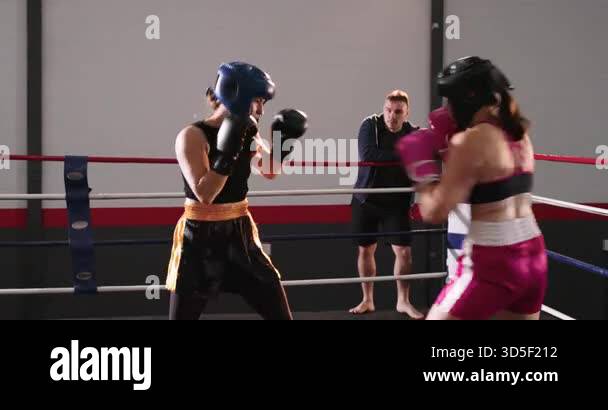 Pink boxer initiating jab black boxer blocking and countering under ...