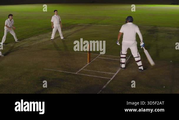 Asian cricket teammates bowling at ground, batsman missing shot ...