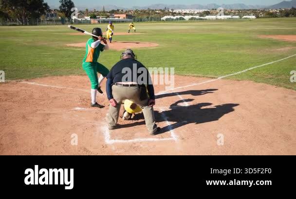 Pitcher preparing fastball, batter swinging through pitch at plate ...