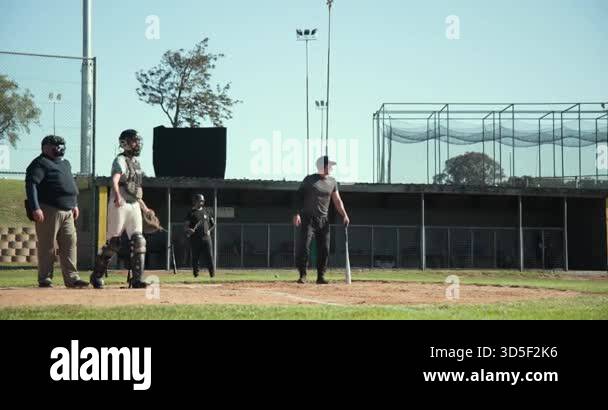 Seeing on-deck arrival prompting male batter gripping aluminum bat ...