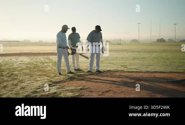 Sunrise sparking diverse baseball teammates walking onto mound ...