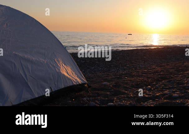 Tent beach sunset. High quality 4k footage Stock Video Footage - Alamy