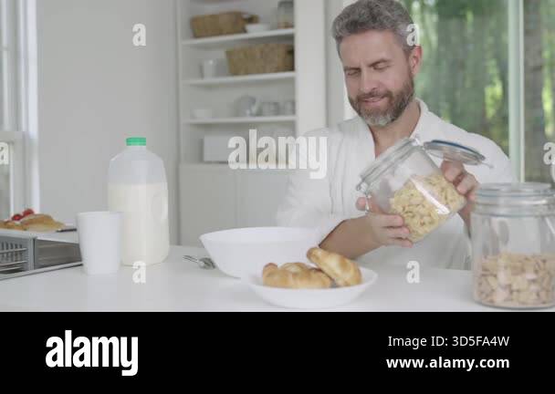 Man eat morning breakfast in kitchen. Guy eat cereal for healthy meal ...