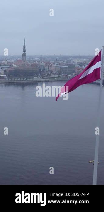 Drone View Of Riga Old Town With Latvian Flag Waving In Foreground ...