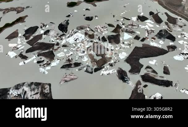 Approaching the boulders of ice in the river with grey water. Ice ...