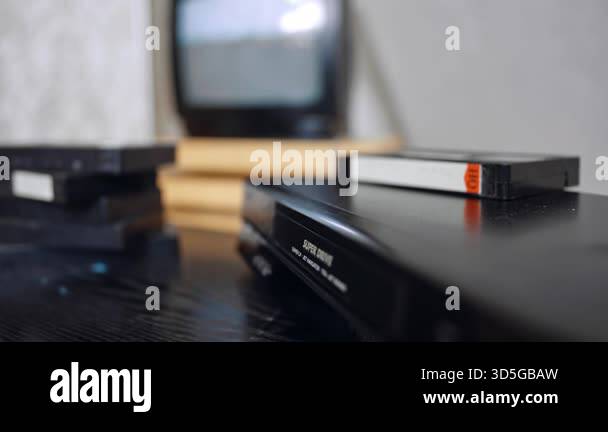 VHS player, several tapes and shimmering screen. A cassette appears ...
