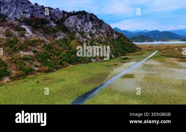 Green rocky islands and waterscape at the foot covered with water lily ...