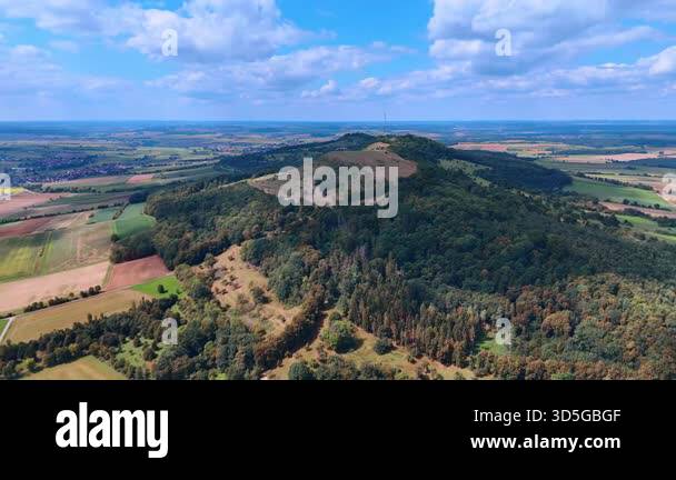 Hilltop valley and open fields. Open valley spreads below hilltop with ...
