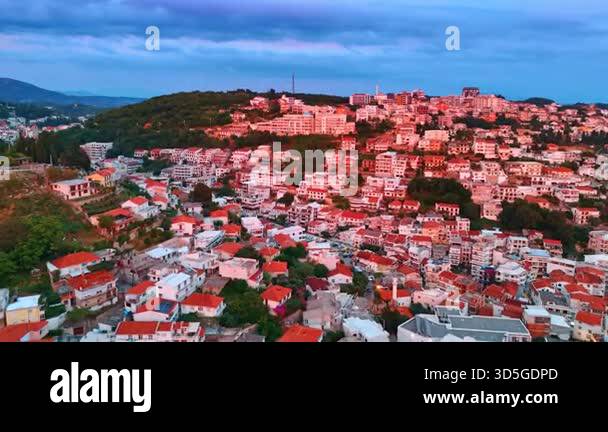 Orange setting sun light colors the multiple villas with red roofs on ...