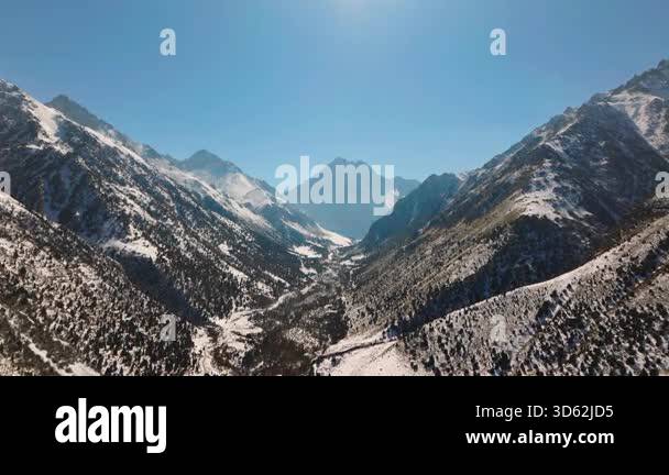 Aerial view captures snow-covered mountains and trees in Kyrgyzstan ...