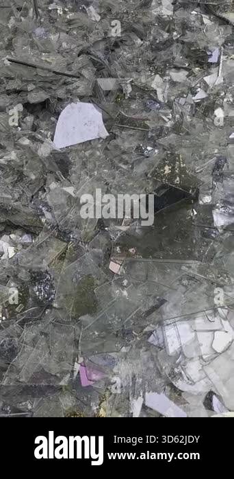 Chaotic scene of broken glass shards reflecting sunlight in a messy ...
