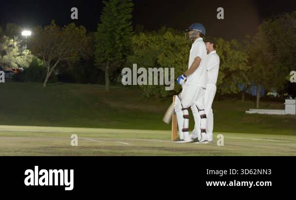 Diverse male pair tapping bat, signaling run before swinging shot ...