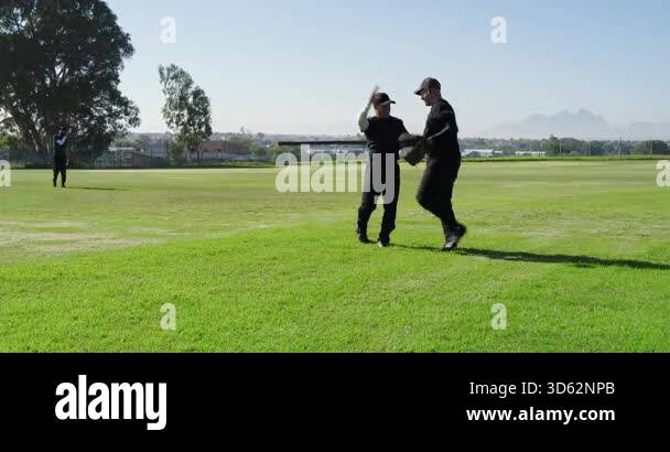 Scooping ball into baseball mitt Diverse male teammates celebrating hug ...