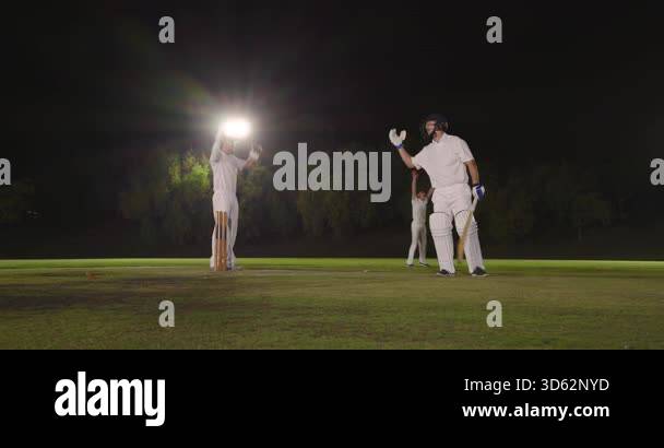 Male bowler releasing ball sparking batsman missing keeper appealing ...