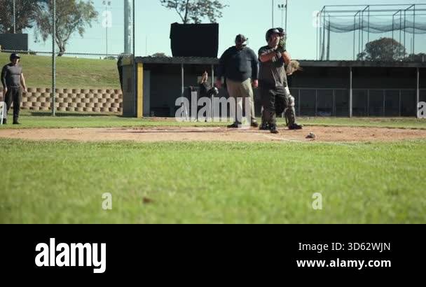 Prompting coach retrieving bat, handing back to youth batter resetting ...