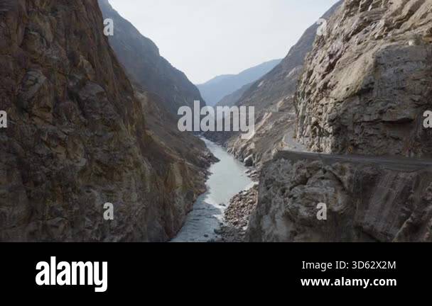 Aerial view of a narrow road winding through a dramatic canyon in ...
